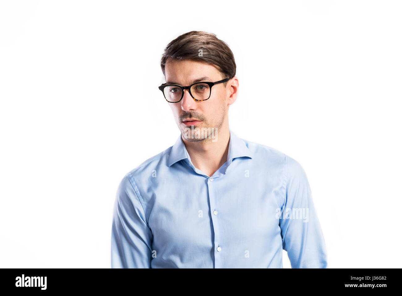 Handsome young man in blue shirt. Studio shot, isolated Stock Photo - Alamy