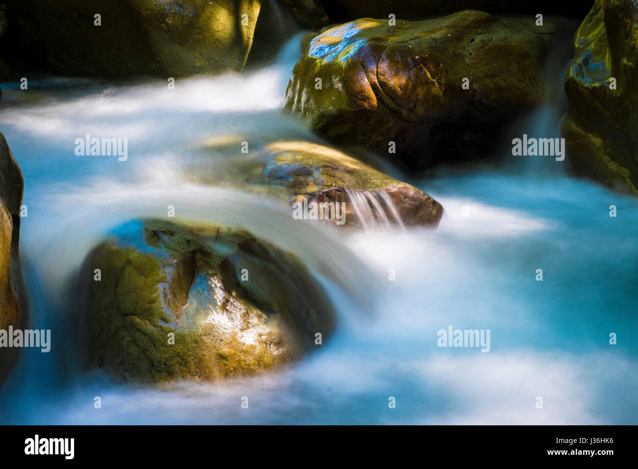 Beautiful river, blurred with motion, flowing among rocks Stock Photo ...