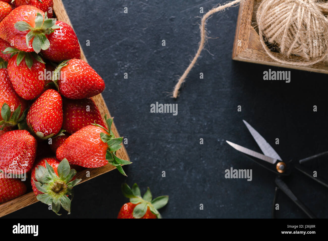 Top view of a wooden box with ripe fresh strawberries, vintage black ...