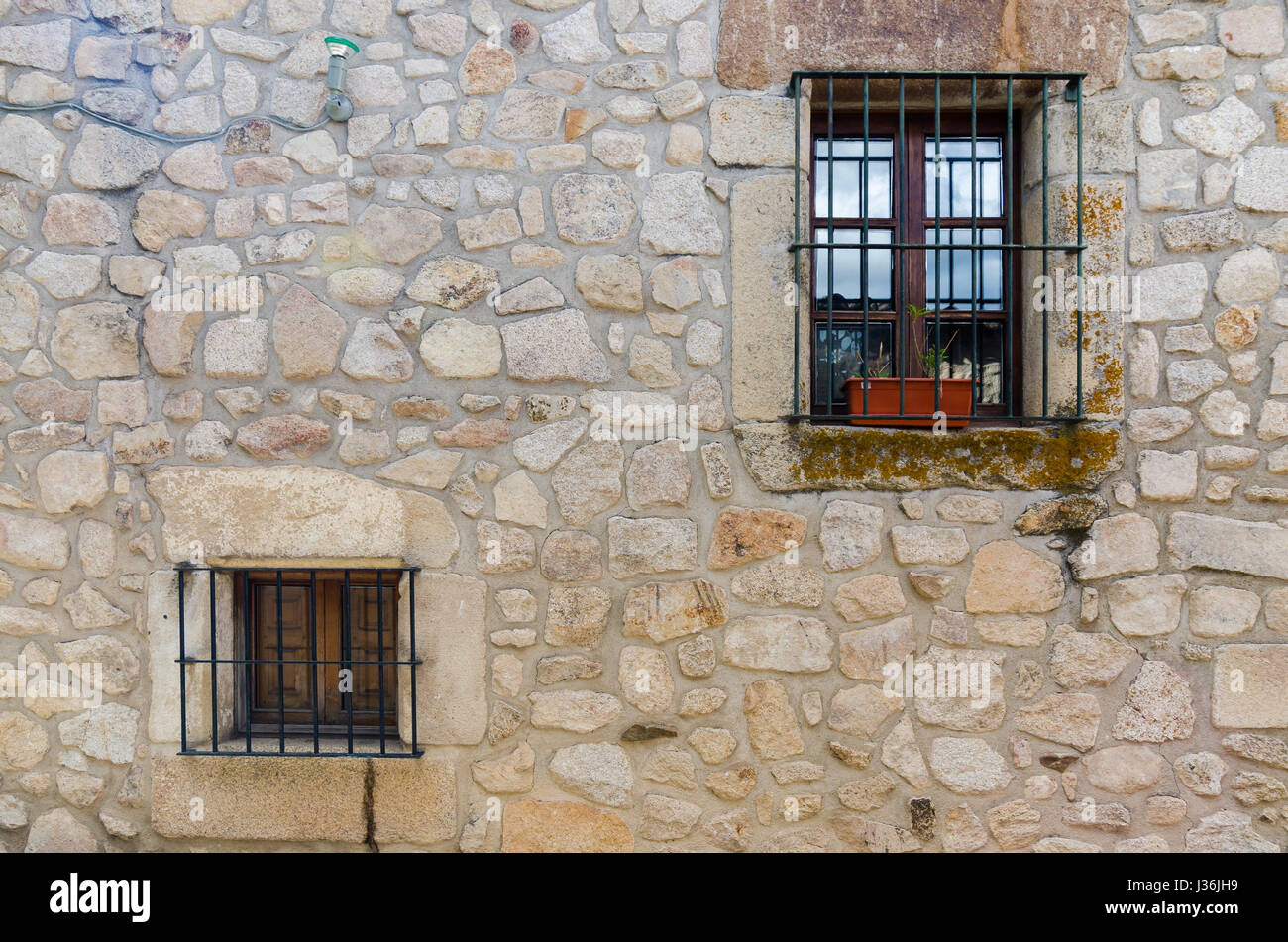 Detail of windows in old stone house in a Extremadura rural village ...