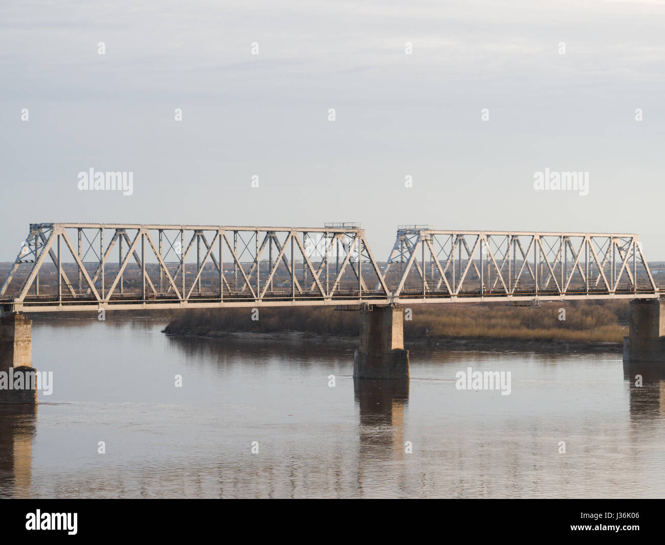 Railway bridge through the river Stock Photo - Alamy