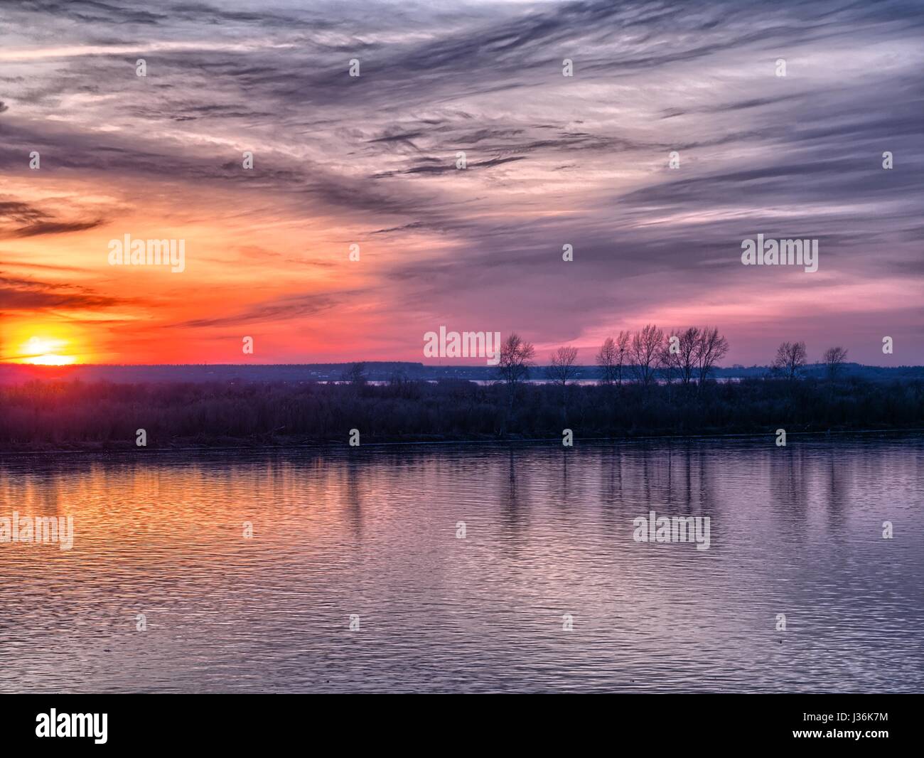 Sunset over the river Stock Photo - Alamy