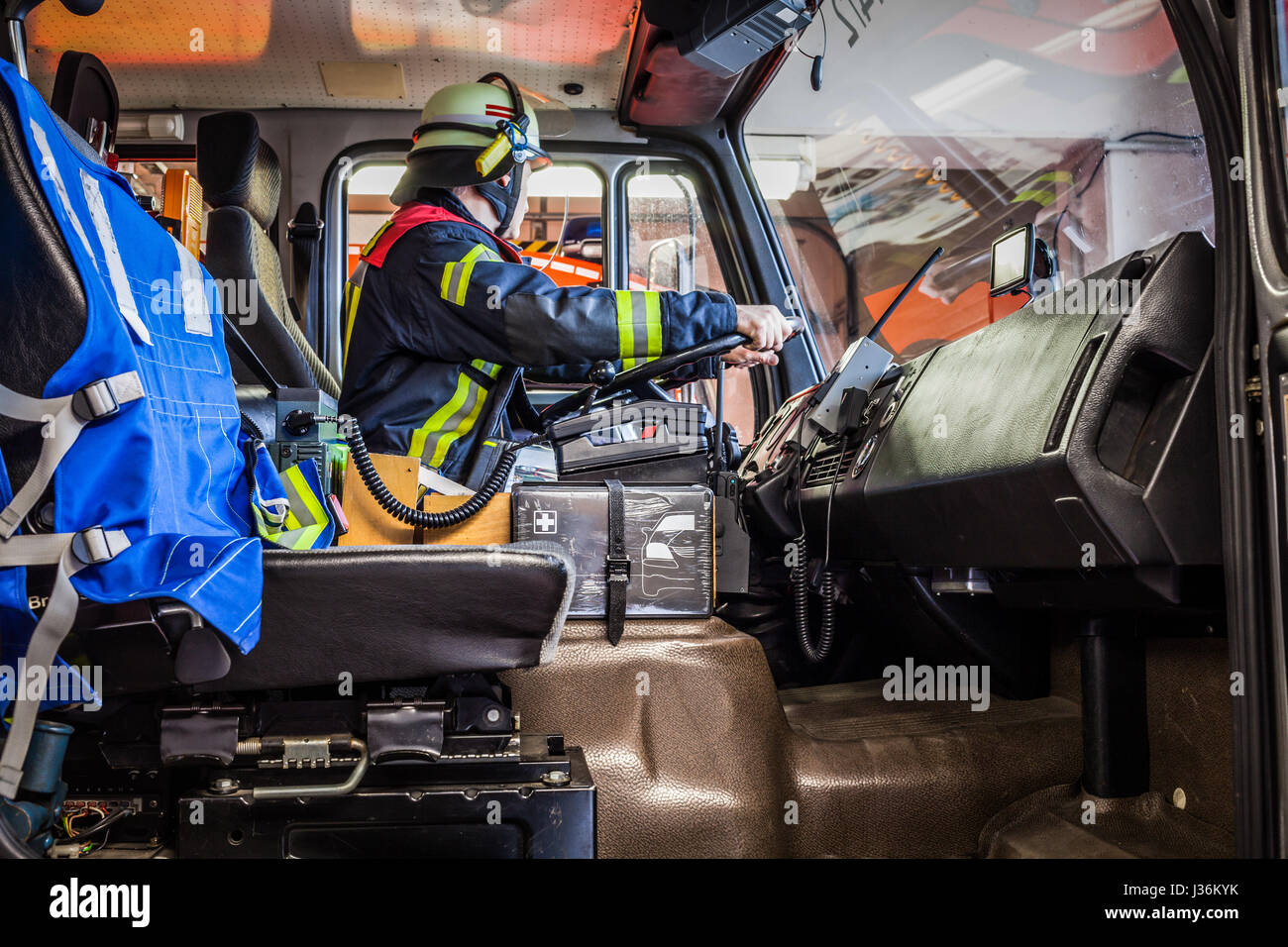 Firefighter drives a emergency vehicle with communication interior view ...