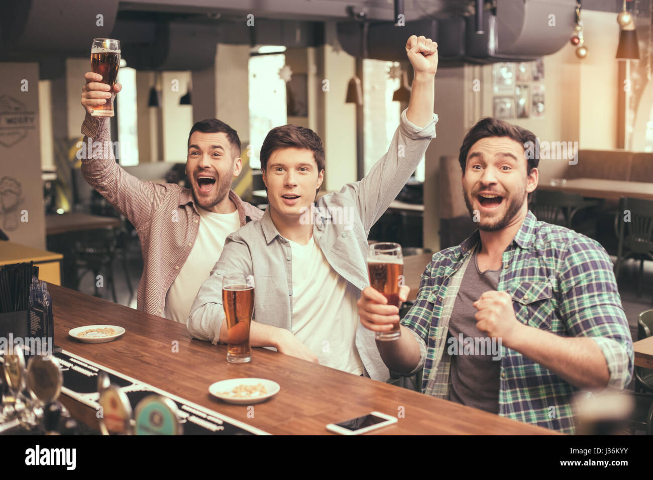 Friends having fun in pub Stock Photo - Alamy