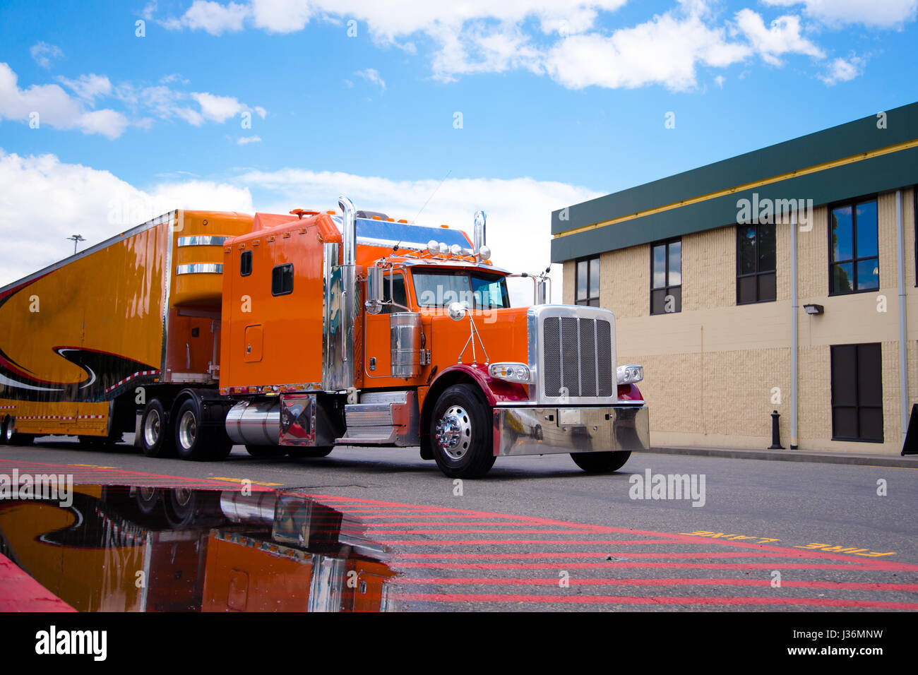 The classic orange powerful American heavy big rig semi truck with ...