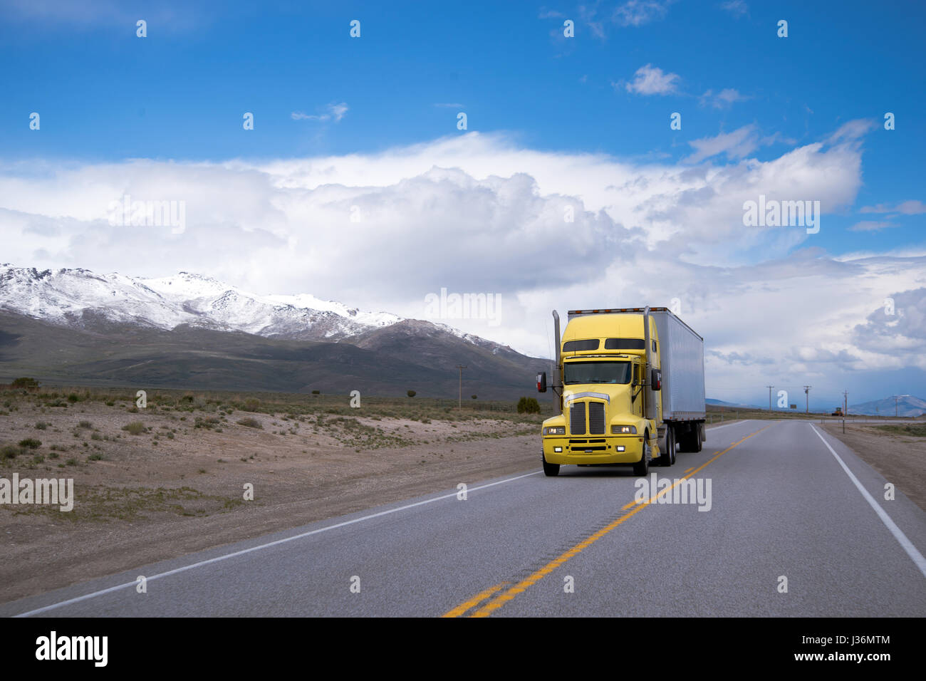 Classic American bonneted big rig semi truck with a long trailer ...