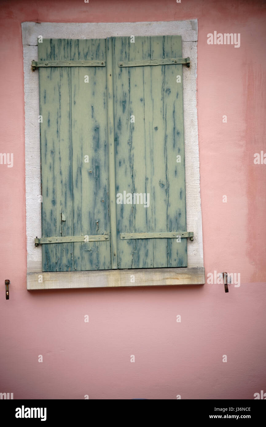 An old wooden and fading closed window shutter on a nostalgic window ...