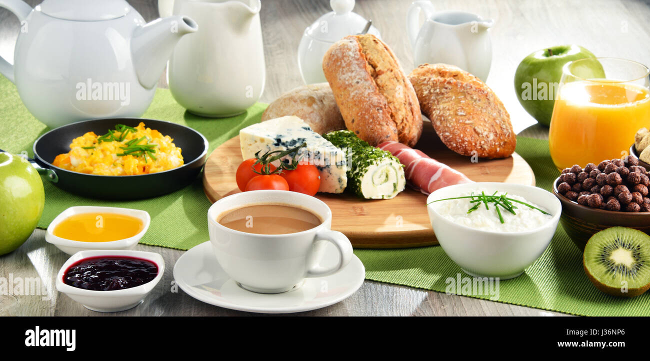 Breakfast served with coffee, orange juice, cheese, cereals and ...