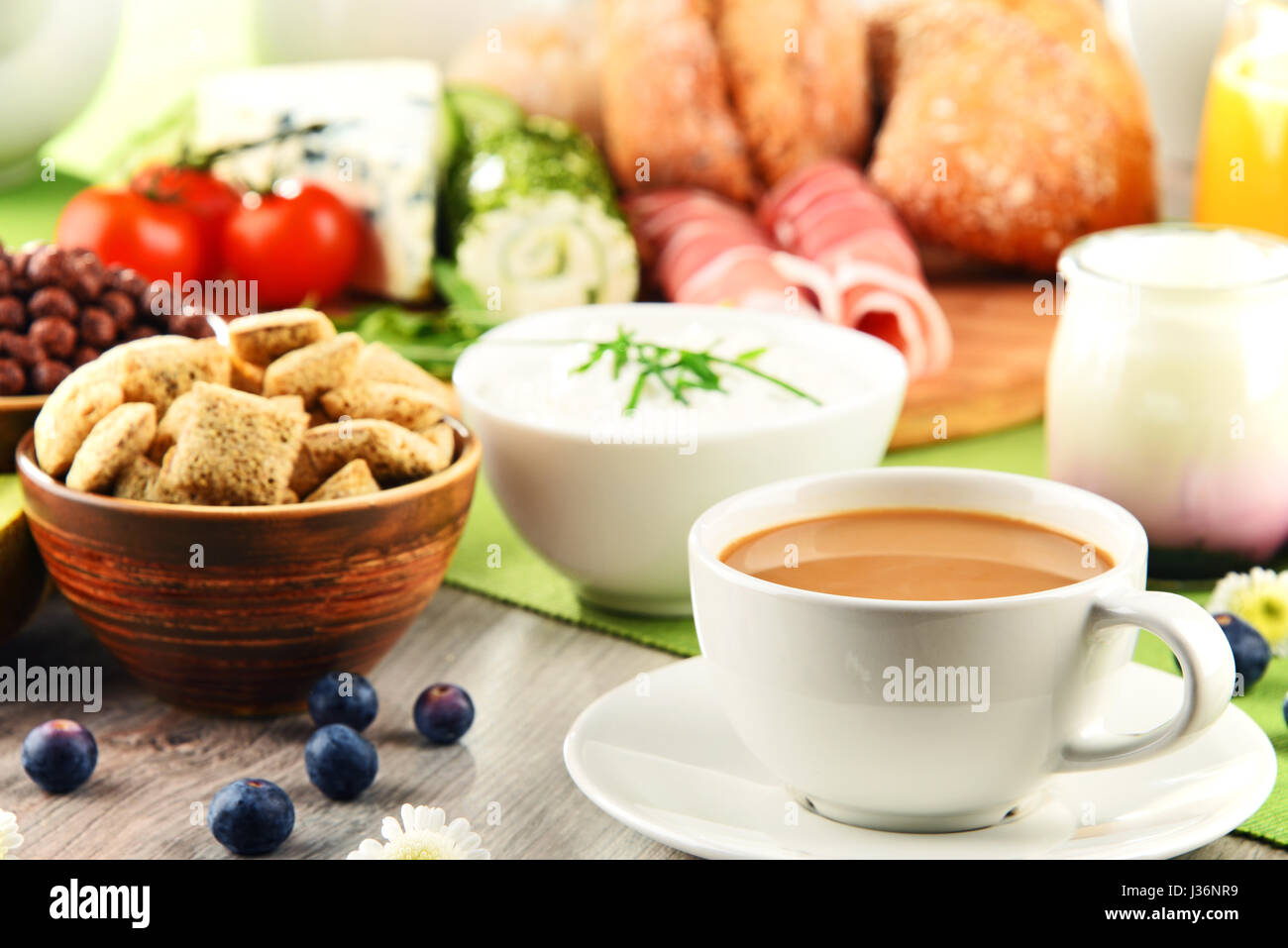 Breakfast served with coffee, orange juice, cheese, cereals and ...