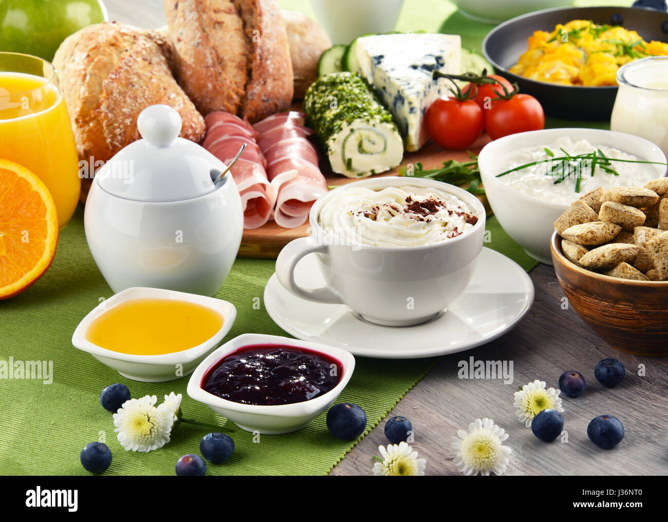 Breakfast served with coffee, orange juice, cheese, cereals and ...