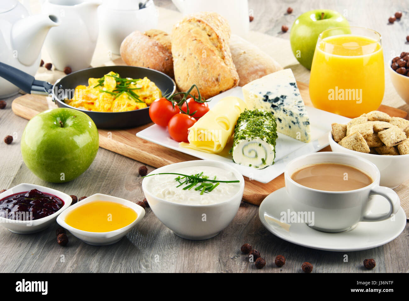 Breakfast served with coffee, orange juice, cheese, cereals and ...