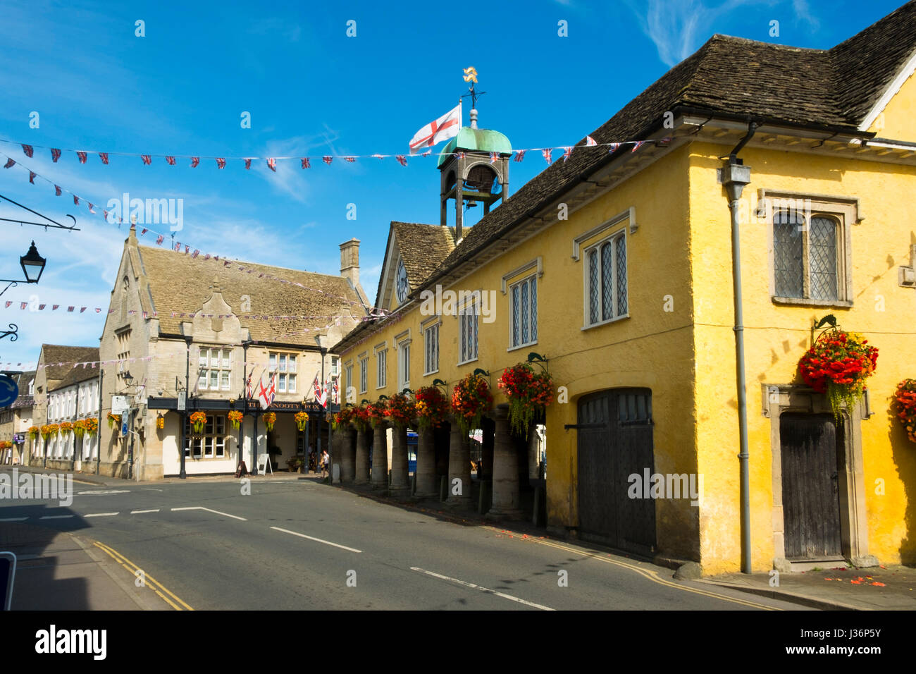Summer sunshine brings a few people to Tetbury on a quiet afternoon ...