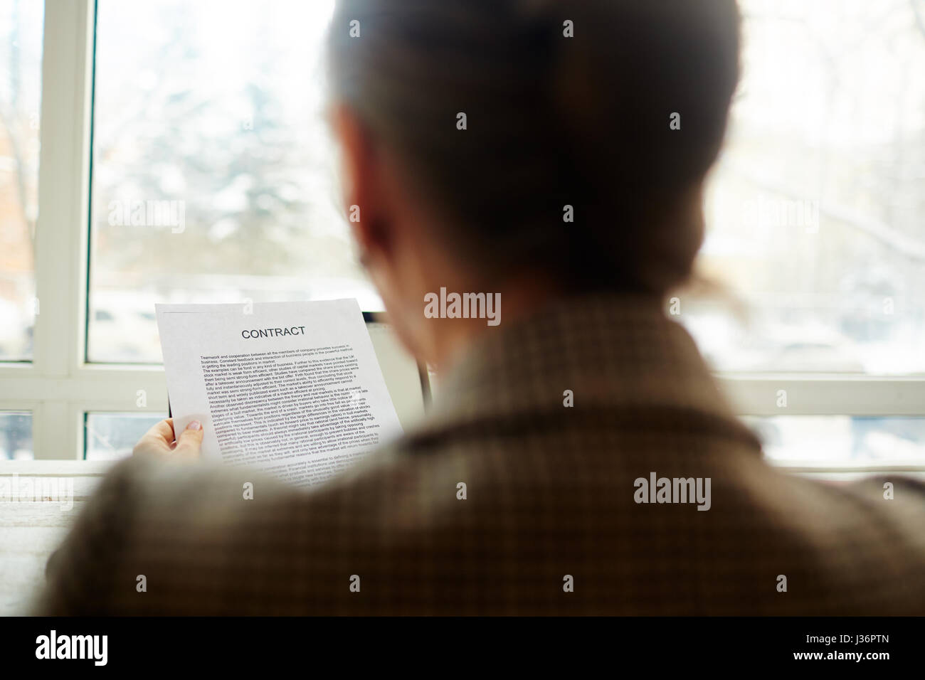 Businesswoman Reading Contract Stock Photo - Alamy