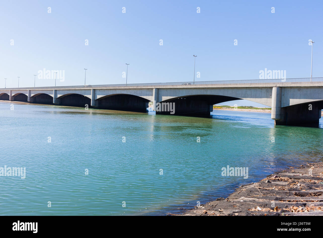 Bridge vehicle crossing river beach coastline structure Stock Photo - Alamy