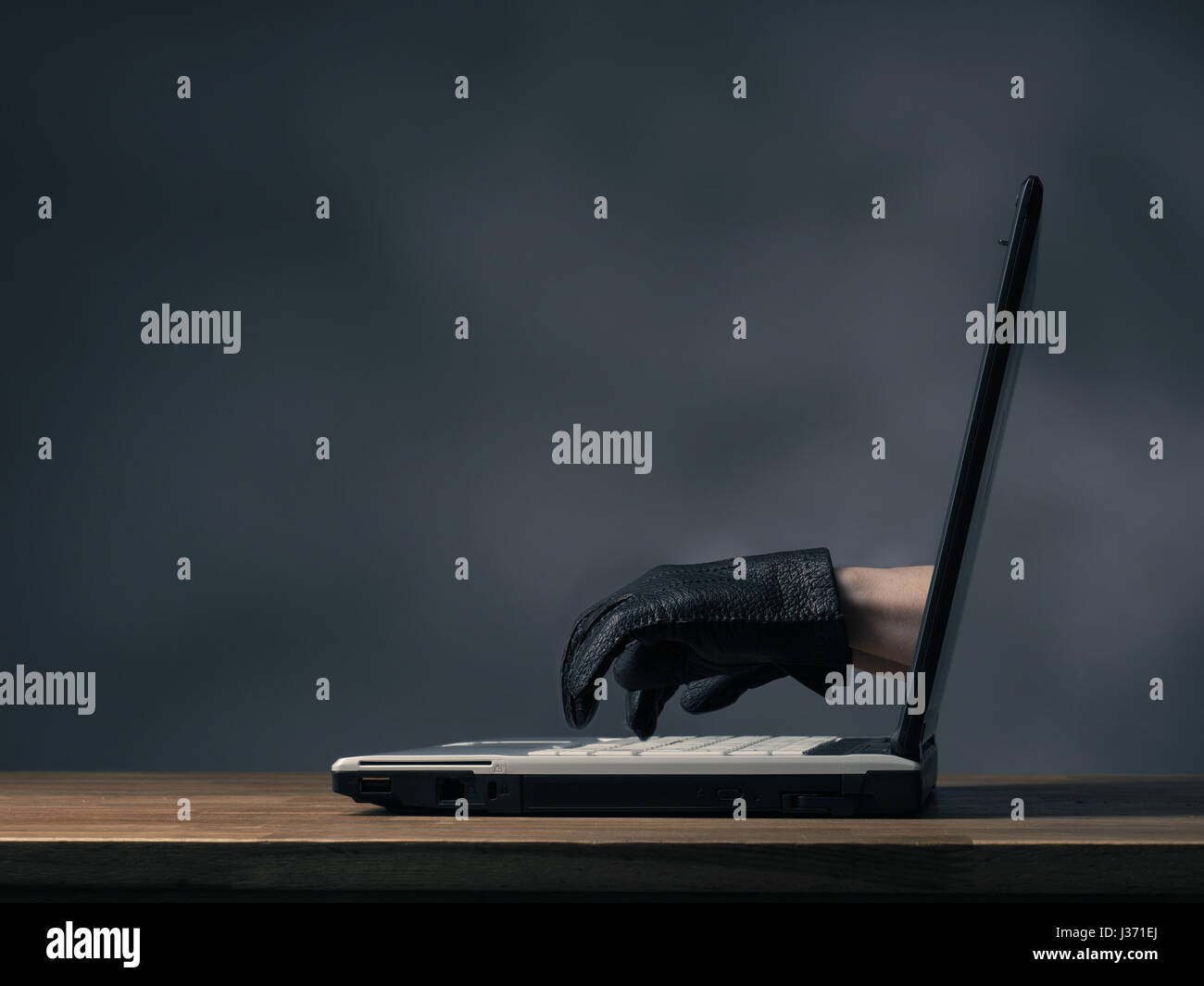 Cyberterrorism or hacking concept image, with laptop and hands with ...