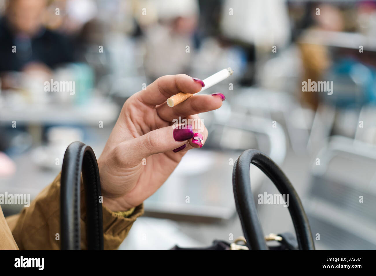 Young woman smoking cigarette purse hi-res stock photography and images ...