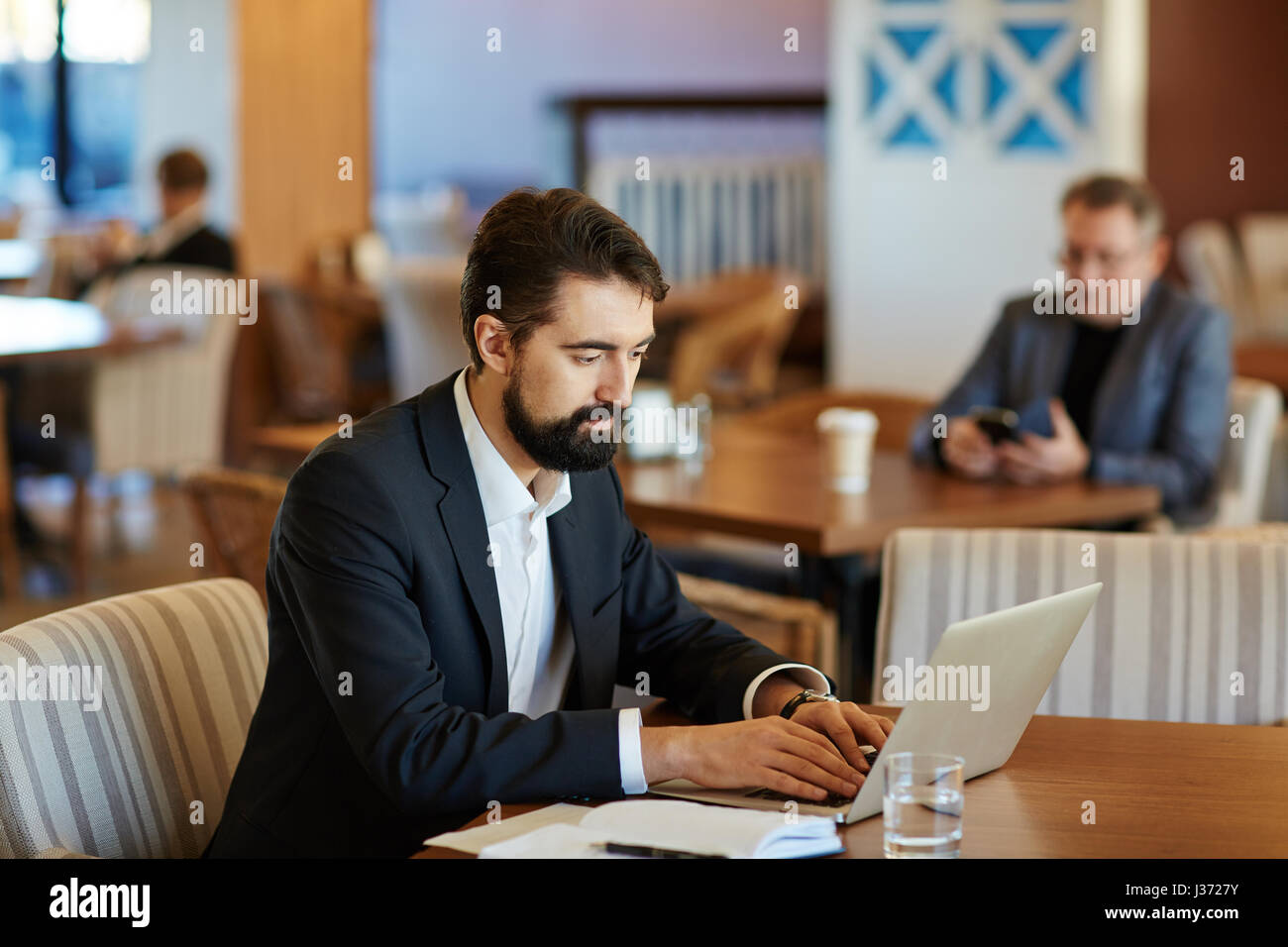 Middle aged businessman using digital hi-res stock photography and ...