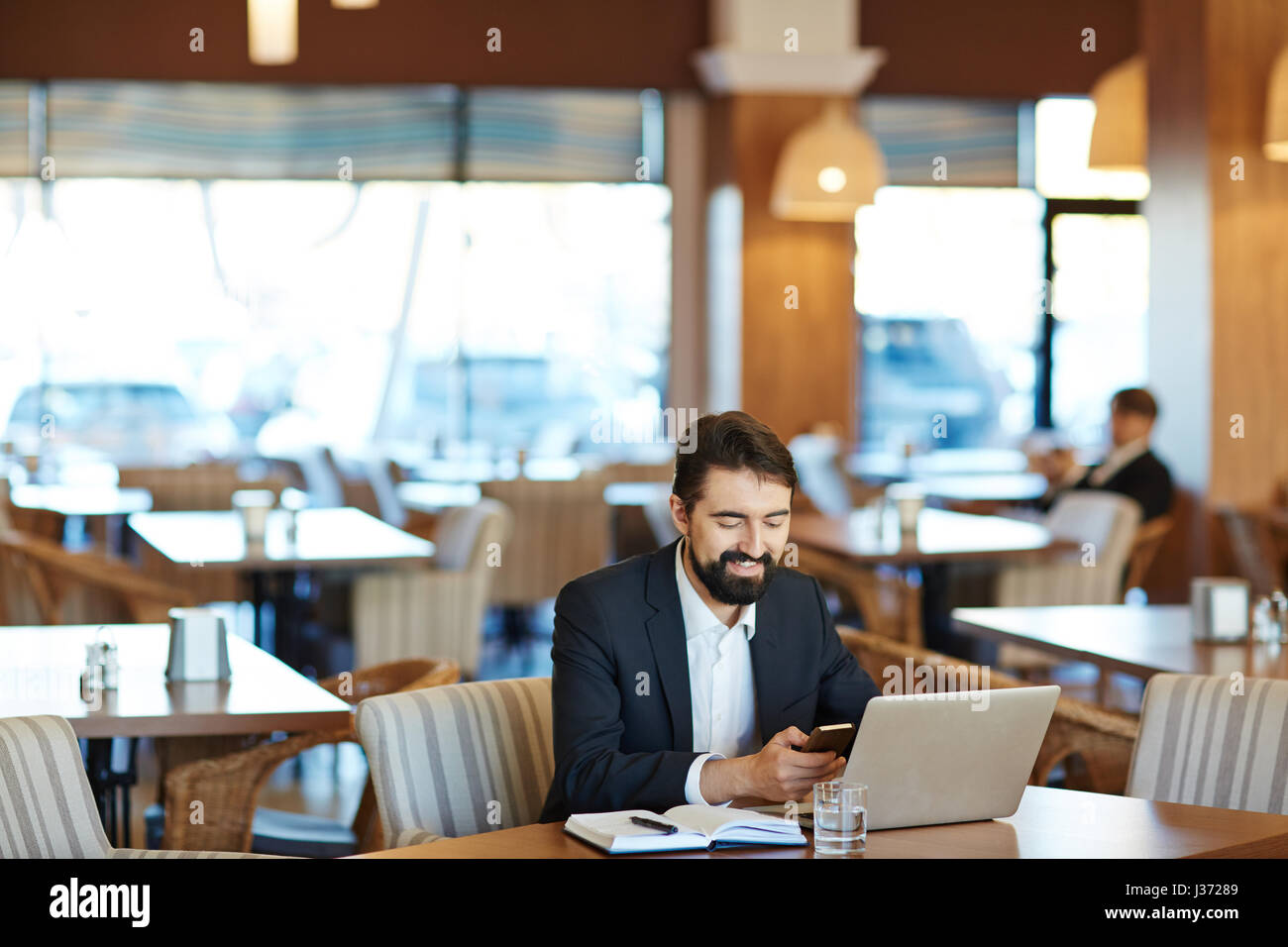 Cheerful Businessman Working in Cafe Stock Photo - Alamy