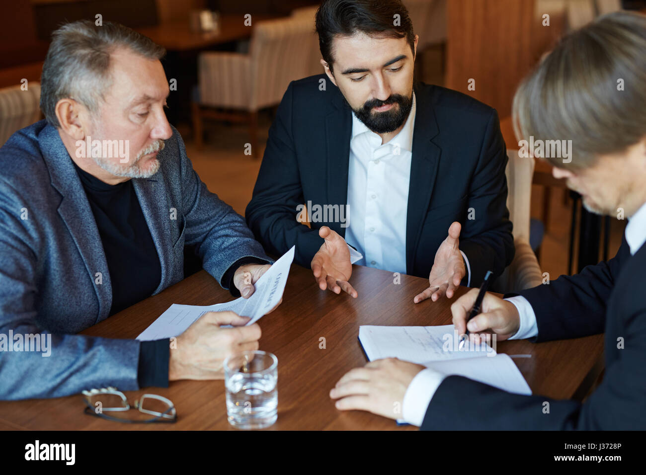 Middle aged businessman sitting in hi-res stock photography and images ...