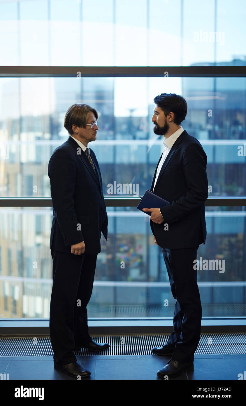 Analyzing Work Results in Office Lobby Stock Photo - Alamy