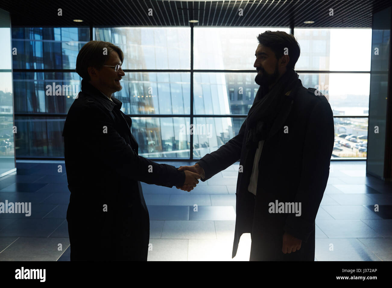 Smiling Colleagues Greeting Each Other Stock Photo - Alamy