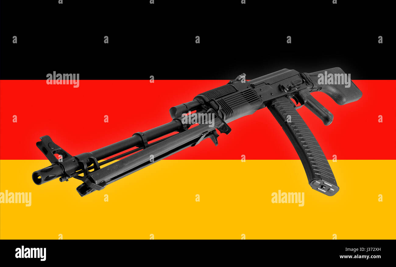 Weapon - A close up black Assault rifle to the Germany of a flag ...