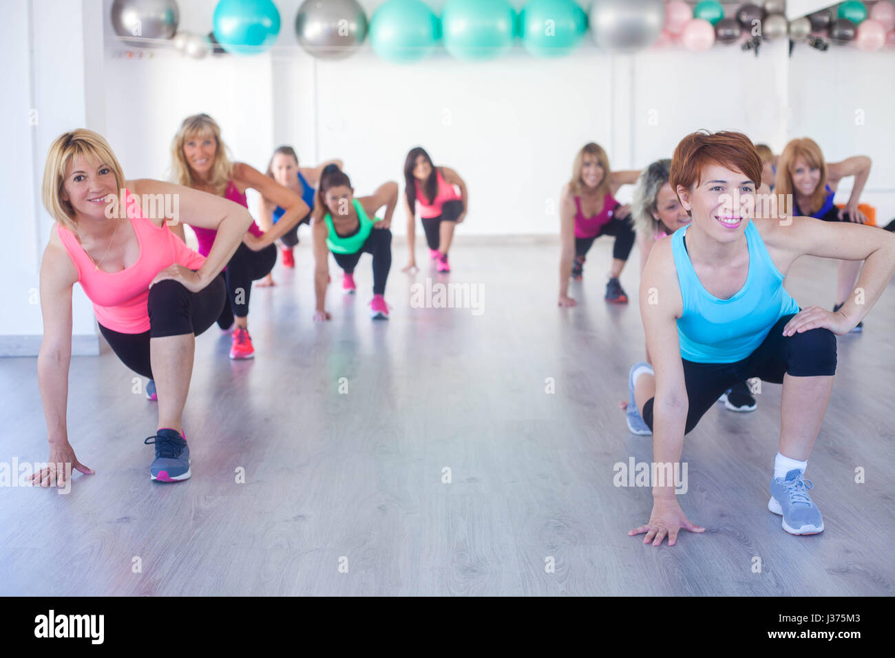 warming up and stretching at exercise class Stock Photo - Alamy