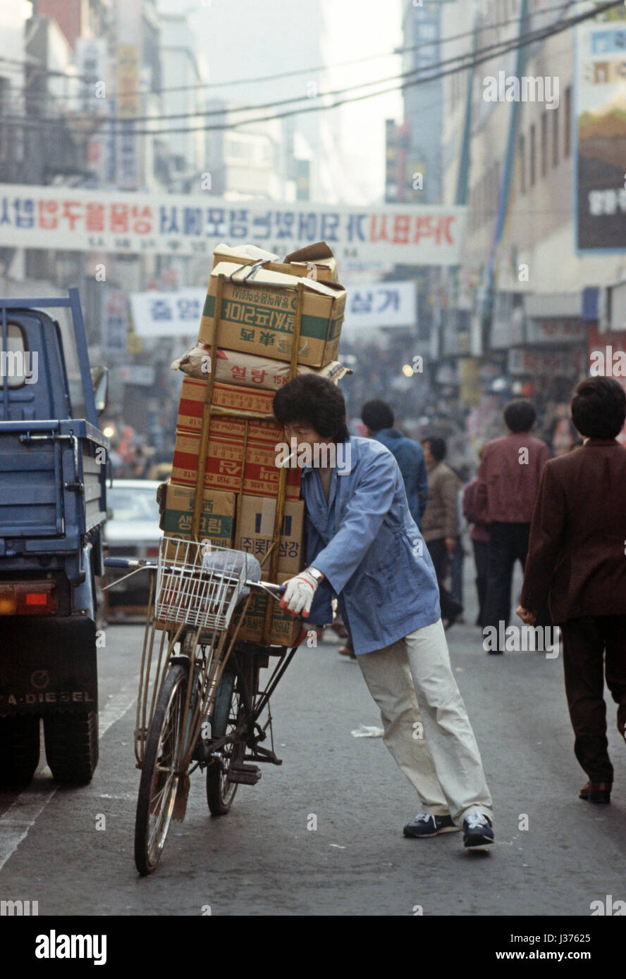 Porter pushing heavy load on bicycle, Seoul City, South Korea, Asia ...