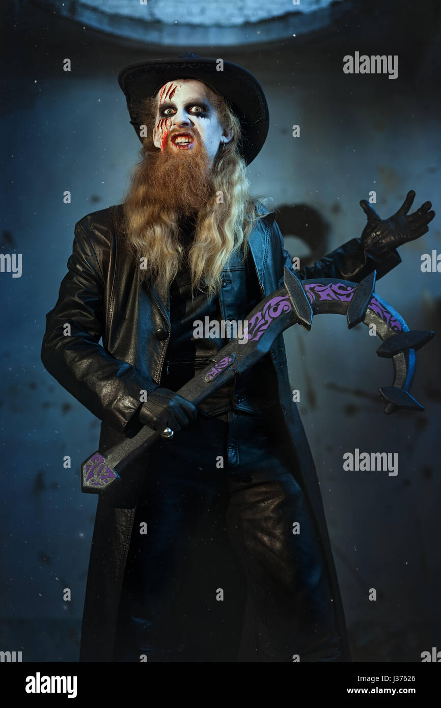 Man holds in his hand a sickle, he is an evil and terrible Stock Photo ...