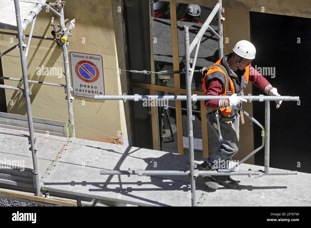 Construction workers on the scaffolding for the renovation of a ...