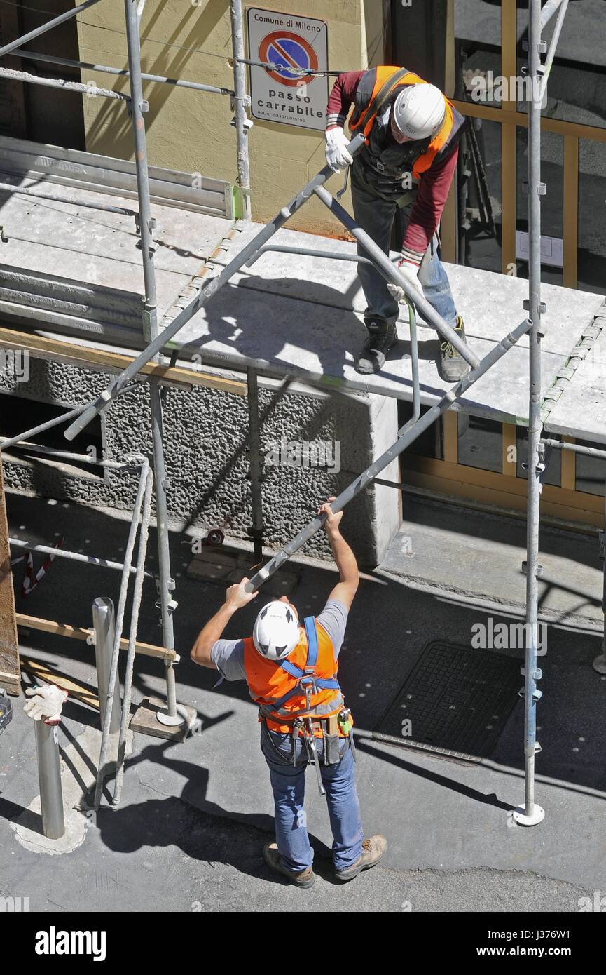 Construction workers on the scaffolding for the renovation of a ...