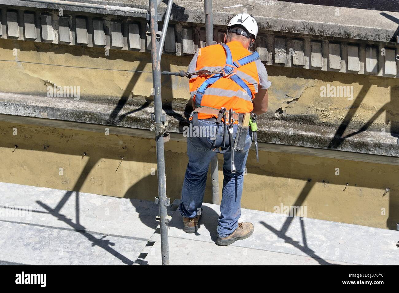 Construction workers on the scaffolding for the renovation of a ...
