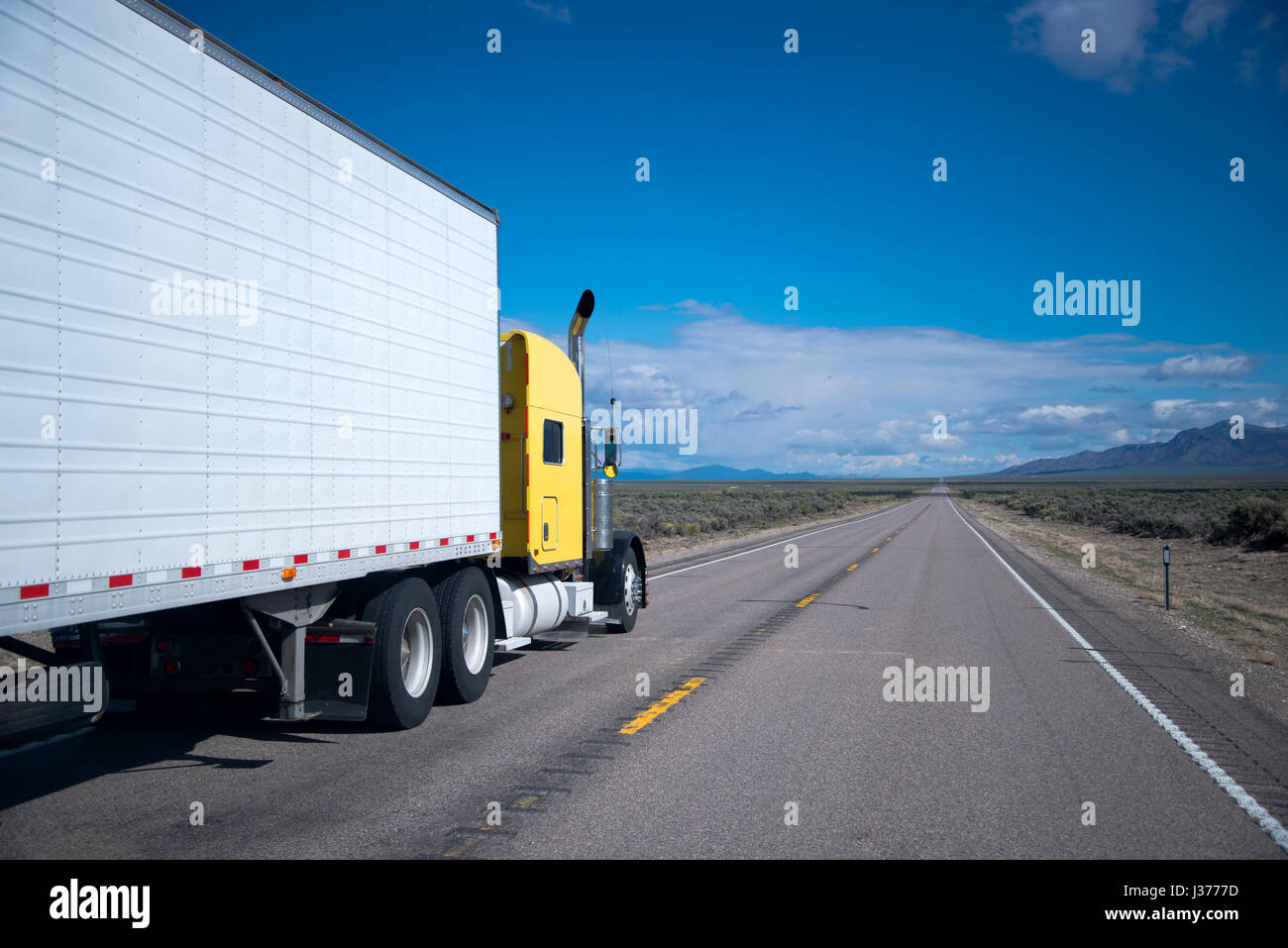 Yellow powerful classic big rig semi truck with high exhaust pipes ...