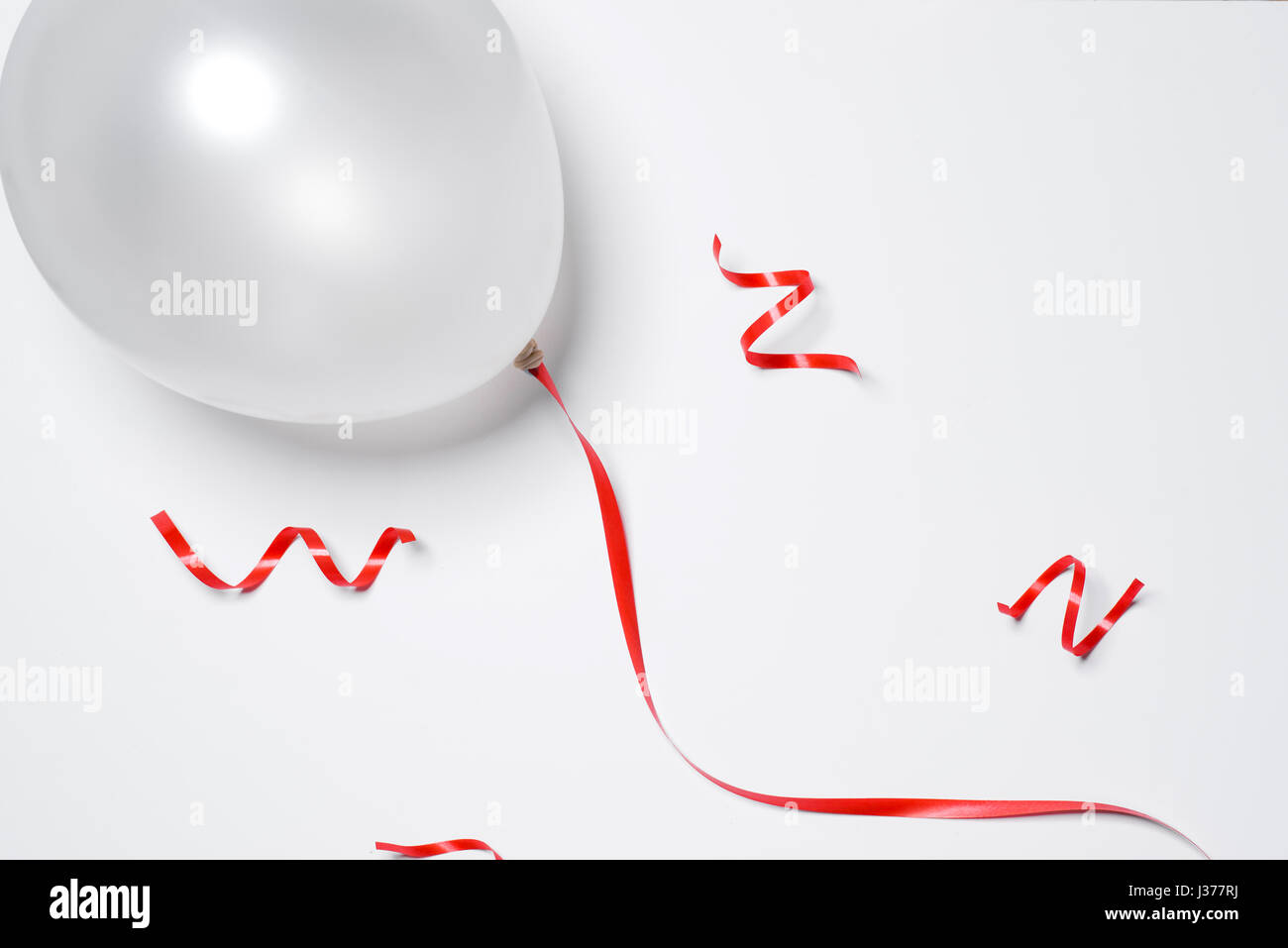 Festive red ribbon and white balloon isolated on white background Stock ...