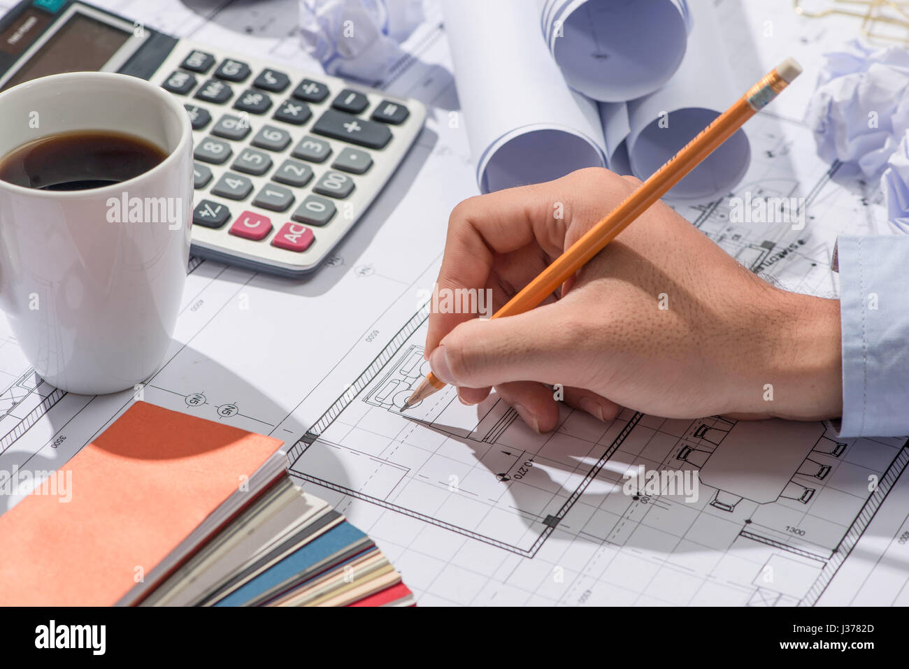 Working on blueprints. Construction project with tools and notebook ...