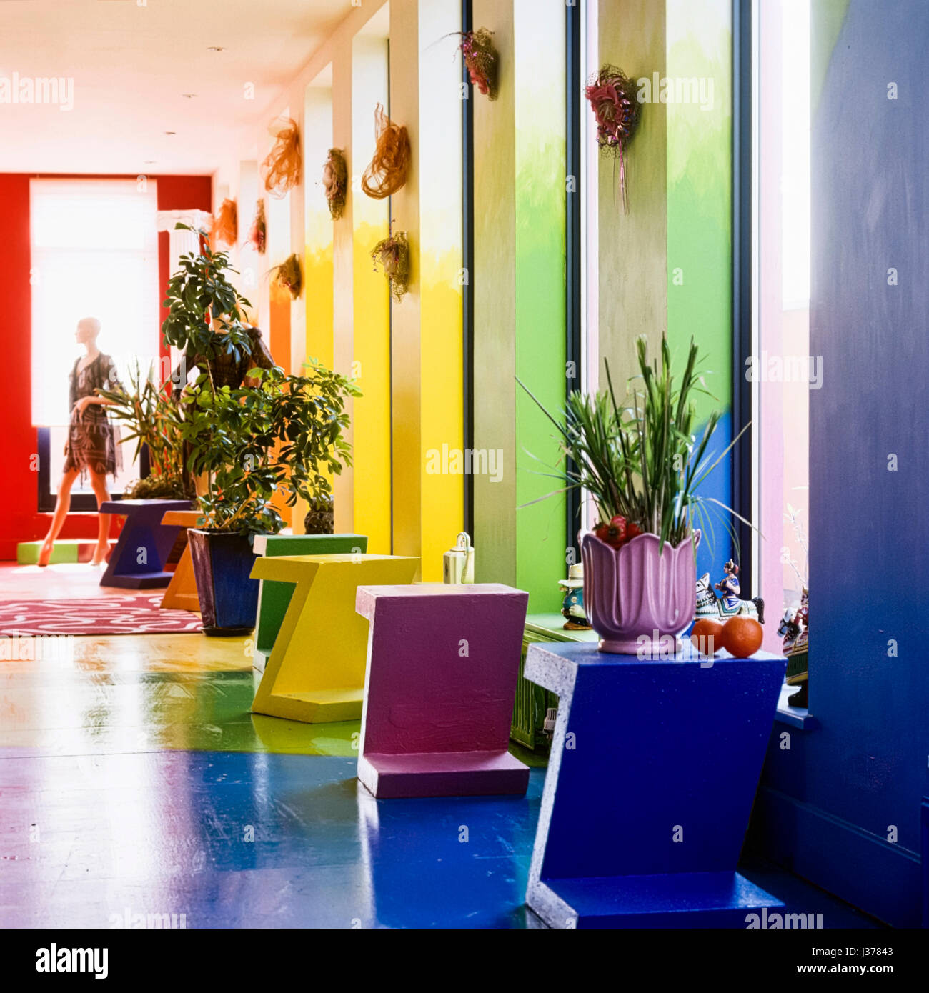 Colorful side tables with pot plants Stock Photo - Alamy