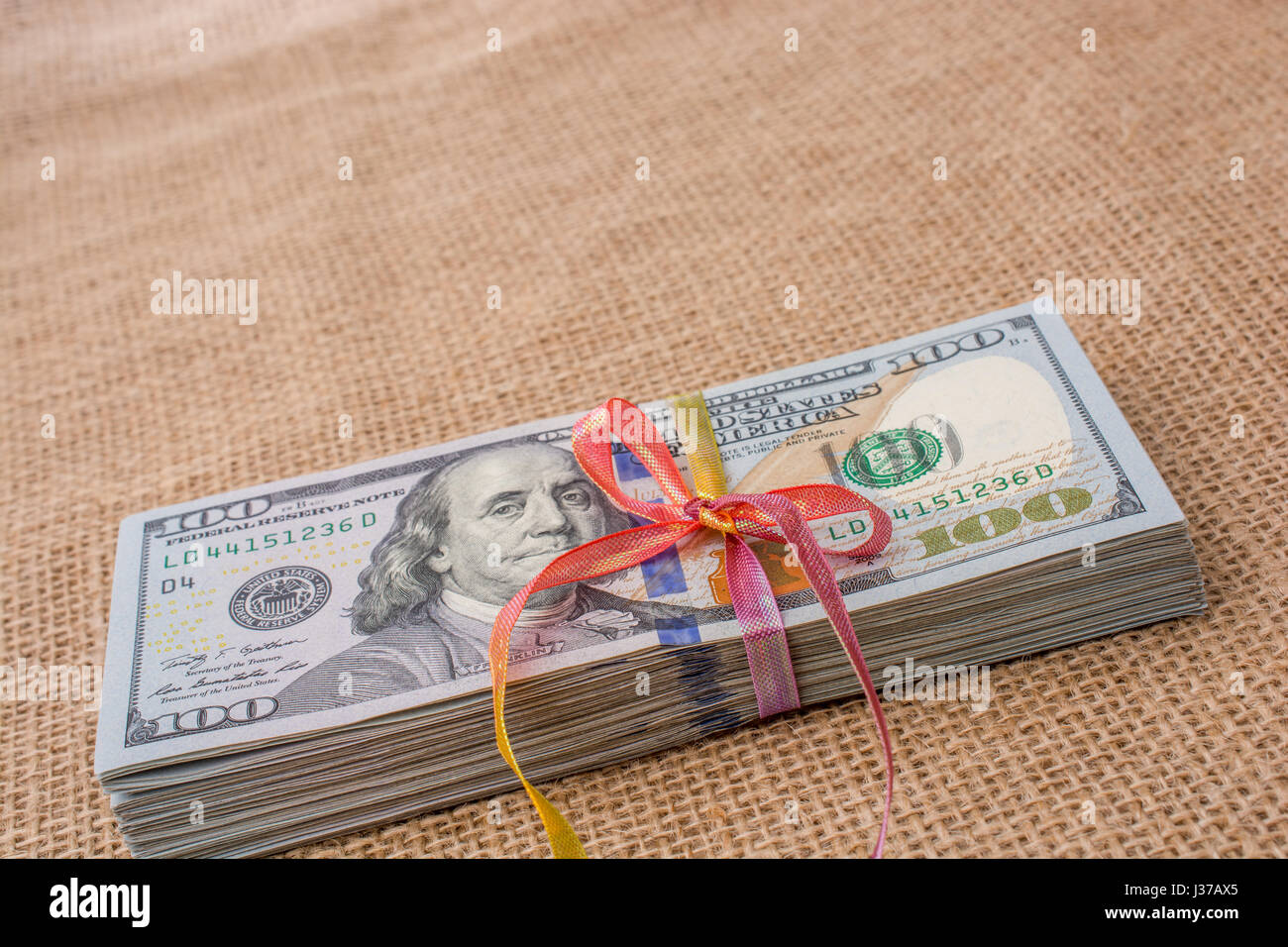Banknote bundle of US dollar tied with colorful a ribbon Stock Photo ...