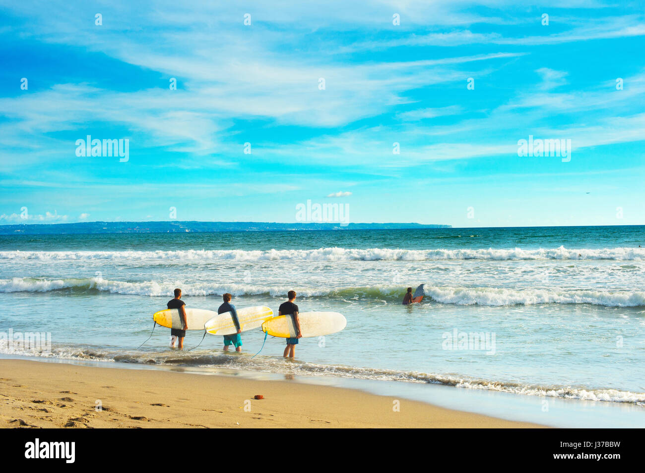 Group of surfers ready to surf on the beach. Bali island, Indonesia ...