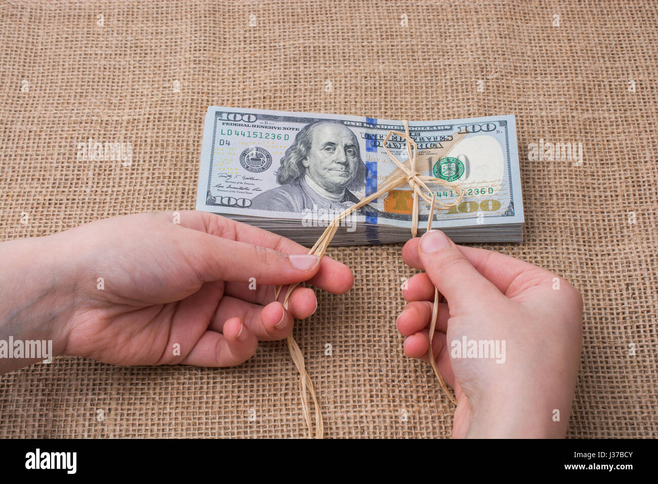 Banknote bundle of US dollar tied with colorful a ribbon Stock Photo ...