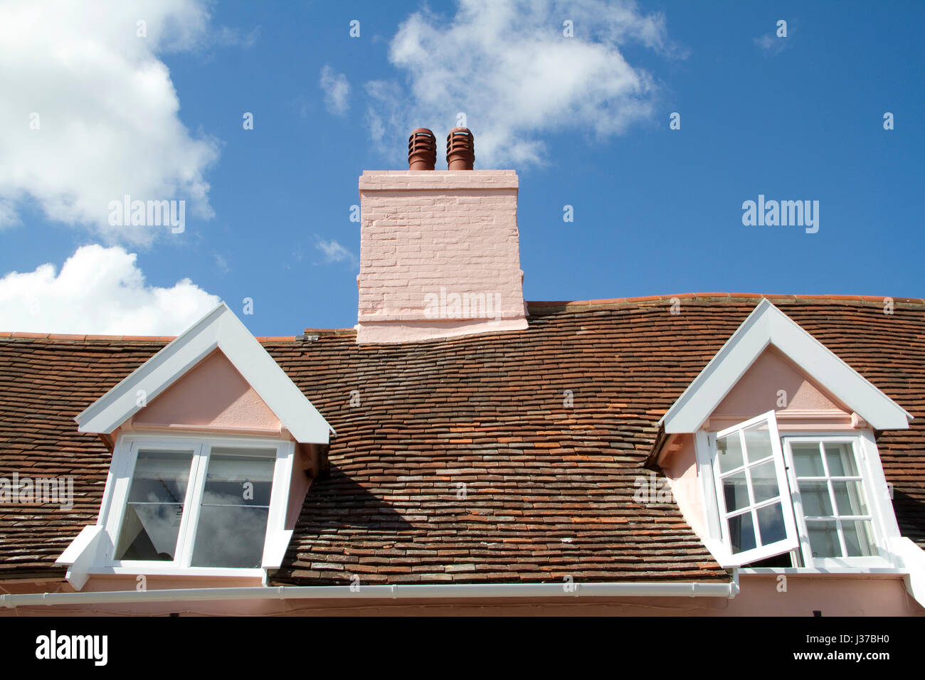 Period chimneys and gable windows against a blue sky Stock Photo - Alamy