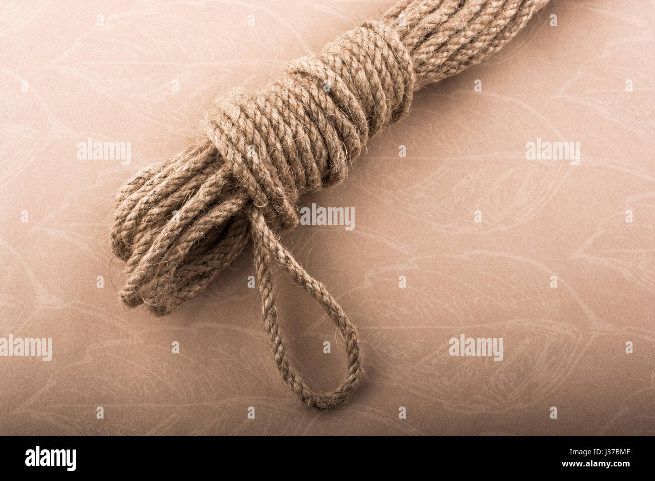 Bundle of linen rope in a sbrown background Stock Photo - Alamy