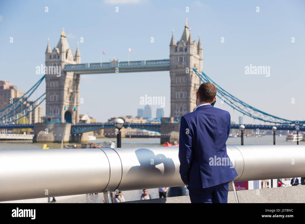 Businessman on phone tower bridge hi-res stock photography and images ...
