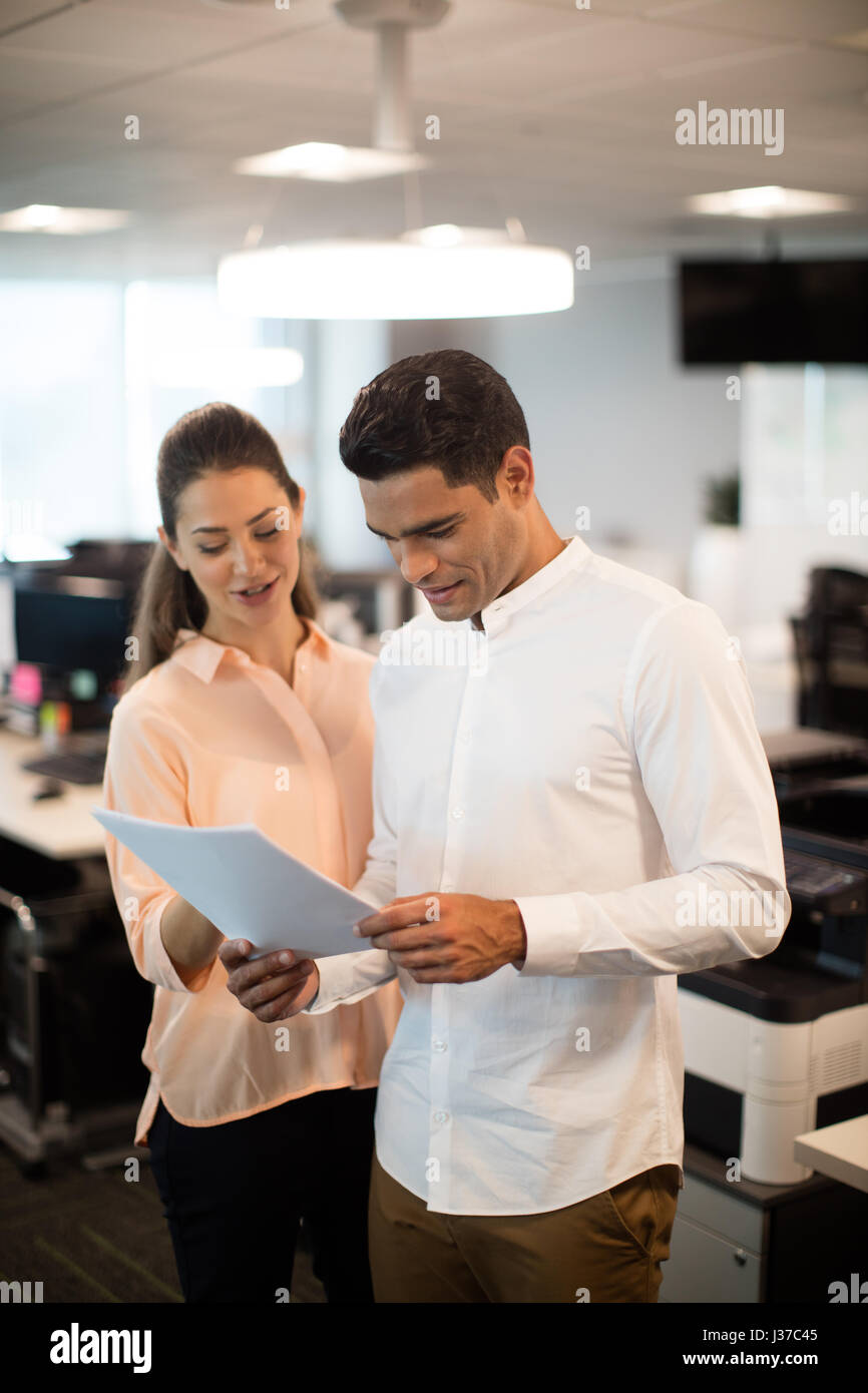 Business people discussing over documents in modern office Stock Photo ...