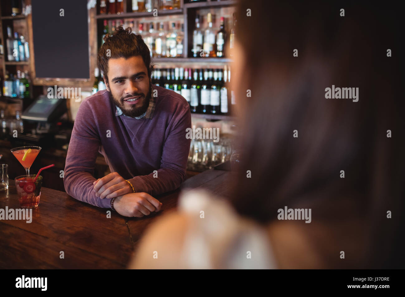 Male bar tender interacting with customer at pub Stock Photo - Alamy