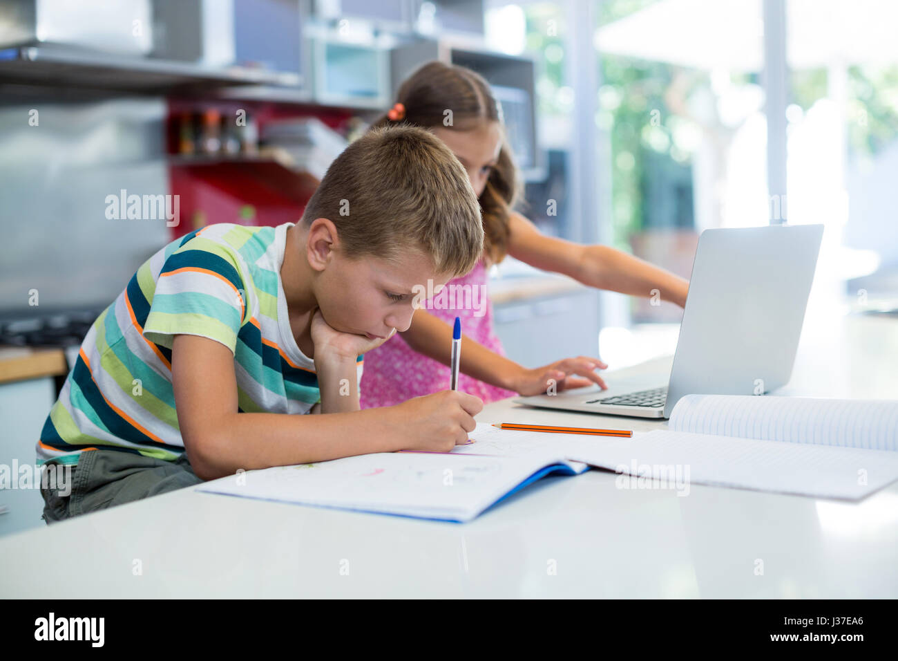 Boy girl doing homework laptop hi-res stock photography and images - Alamy