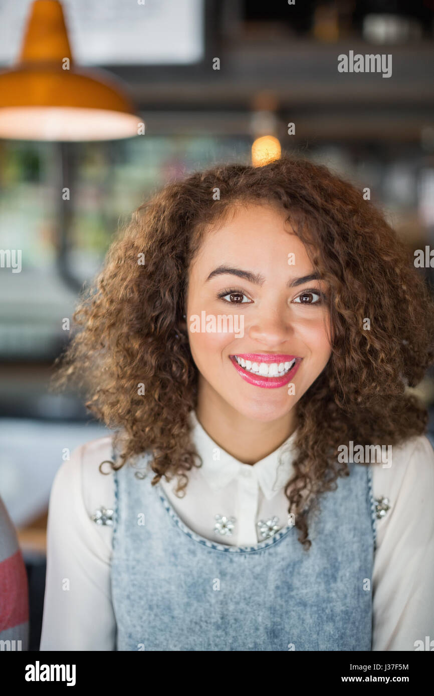 Portrait of happy beautiful woman in pub Stock Photo - Alamy