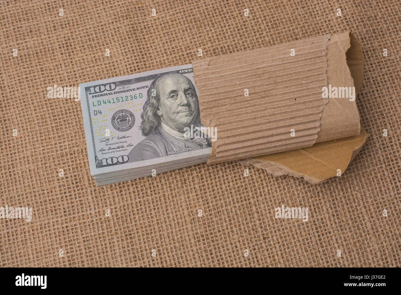Banknote bundle of US dollar partly wrapped in cardboard Stock Photo ...