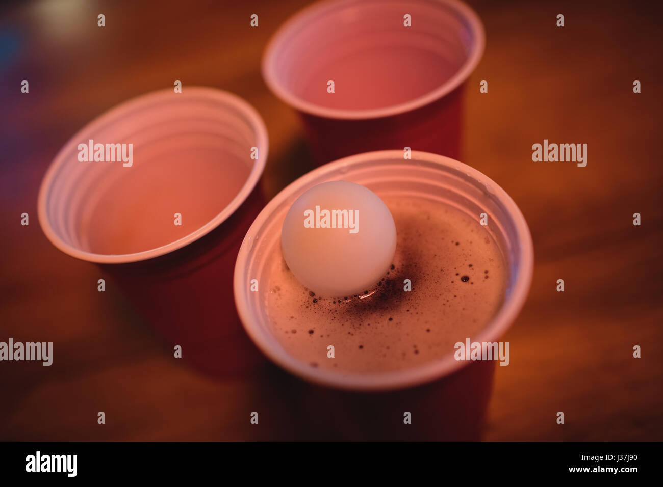 Close-up of pong ball on beer glass in pub Stock Photo - Alamy