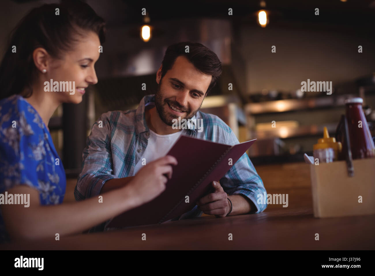 Couple looking at menu in bar Stock Photo - Alamy