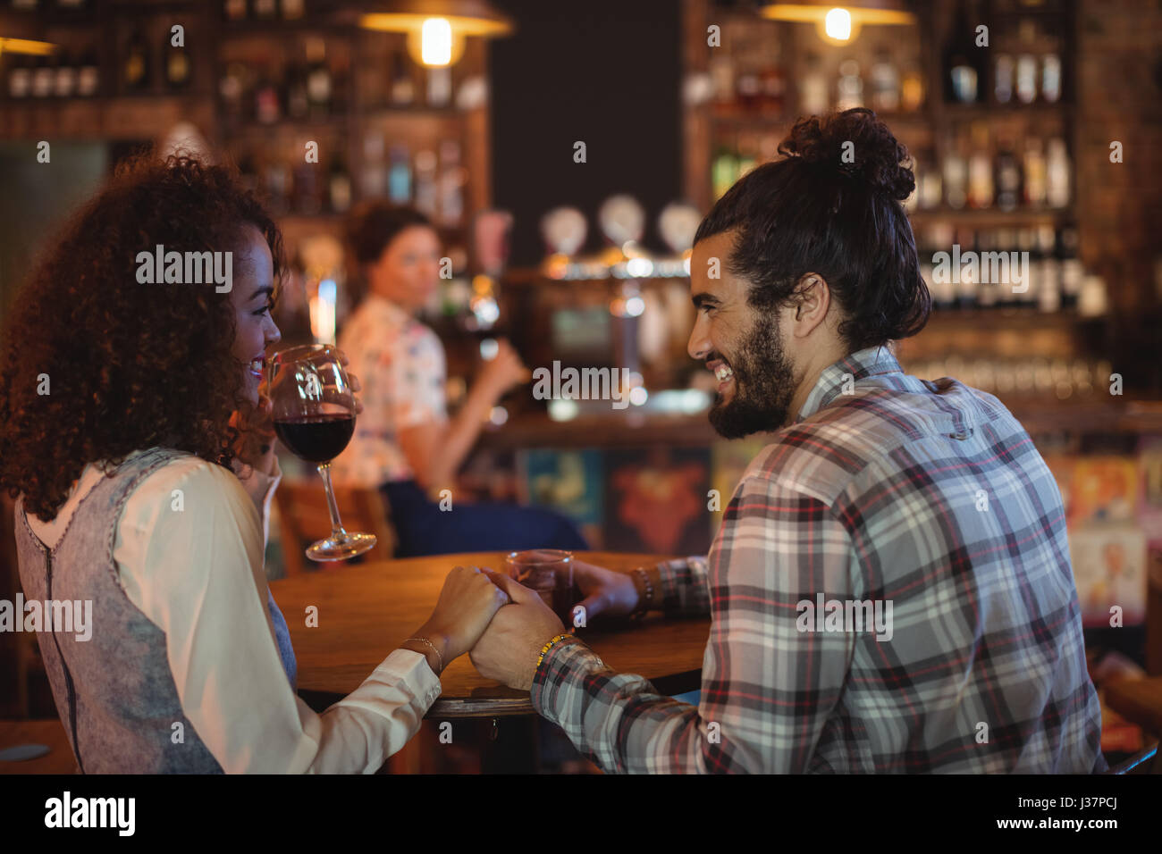 Romantic couple having red wine in pub Stock Photo - Alamy